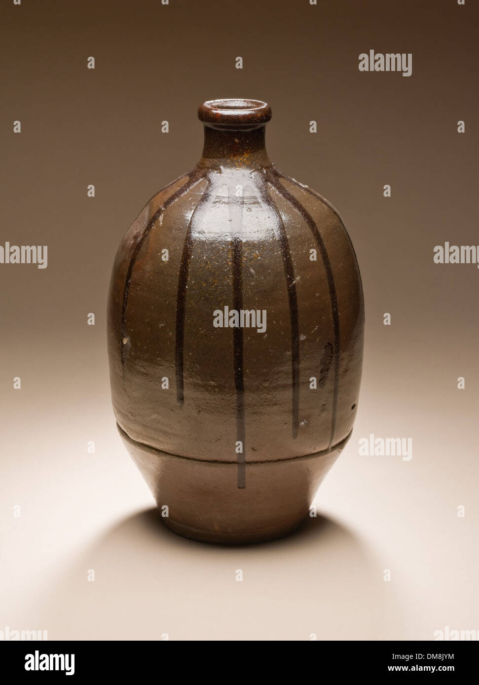 This image features a tokkuri, a traditional Japanese sake bottle. The ...