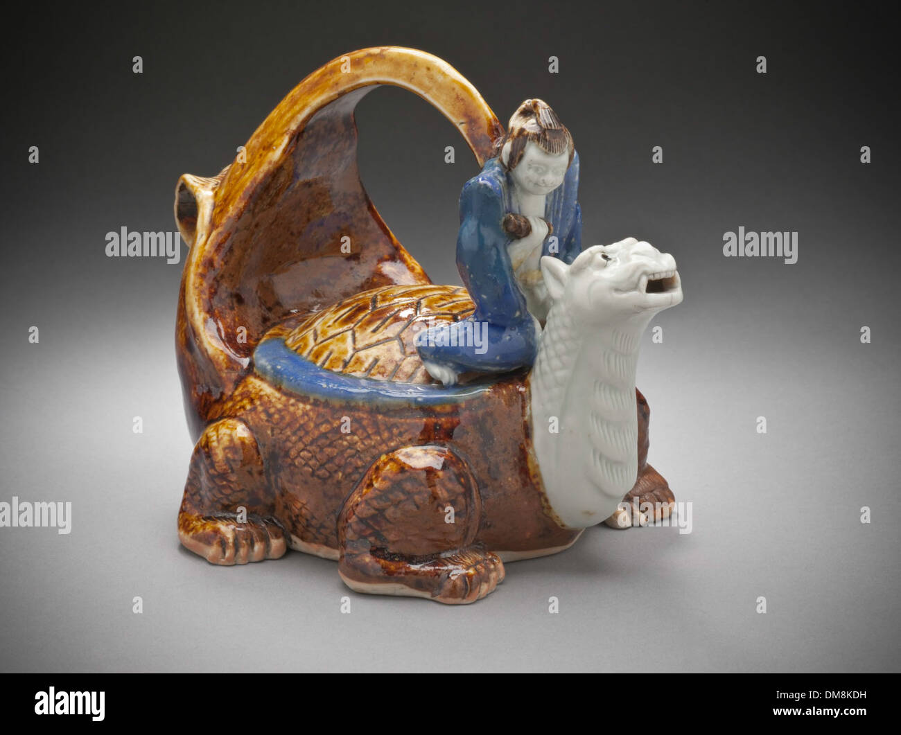 This sake vessel, designed in the form of Urashima Taro riding a long ...