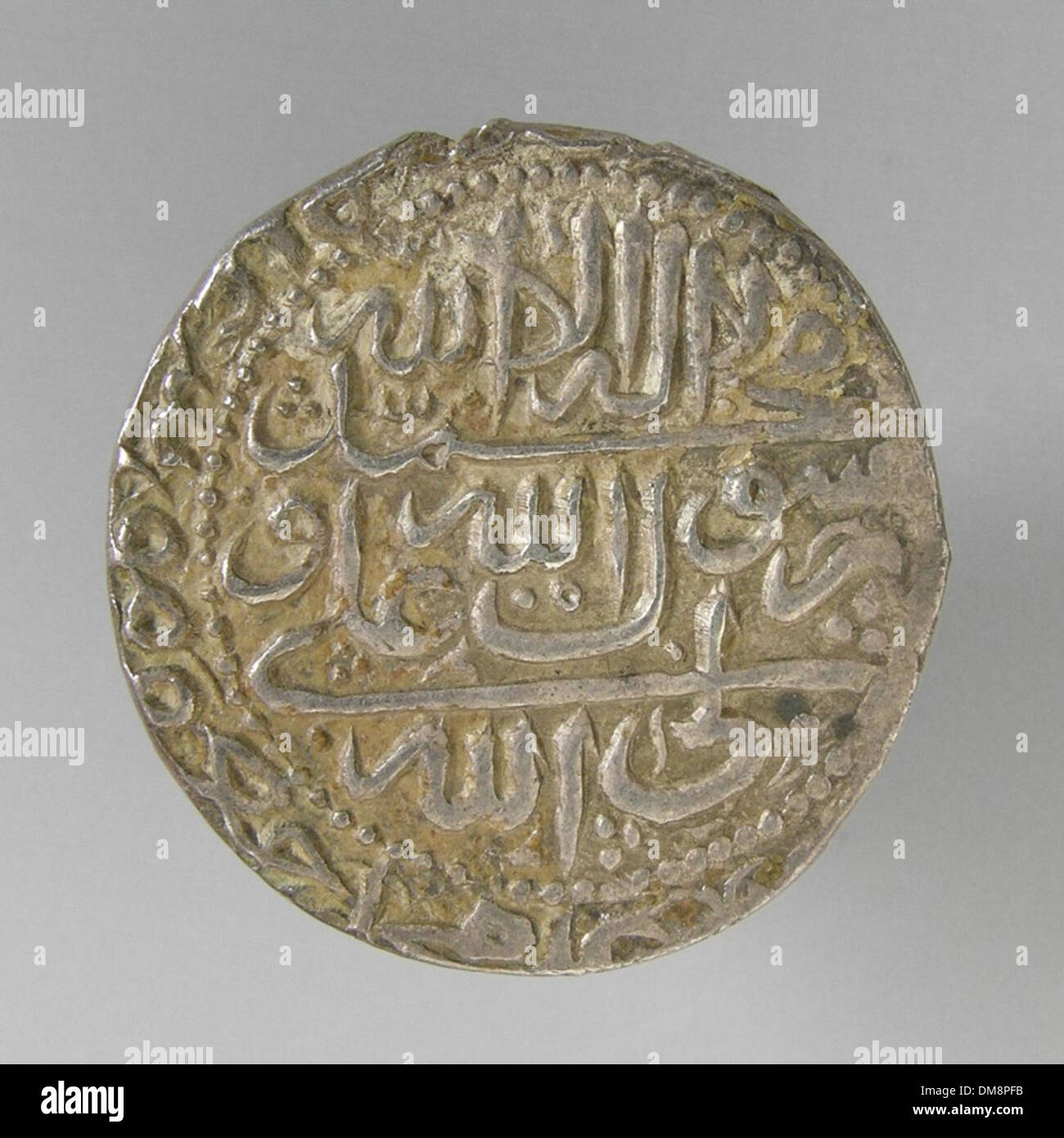 This ancient silver coin from the Middle East, identified as 2002.1.406 ...