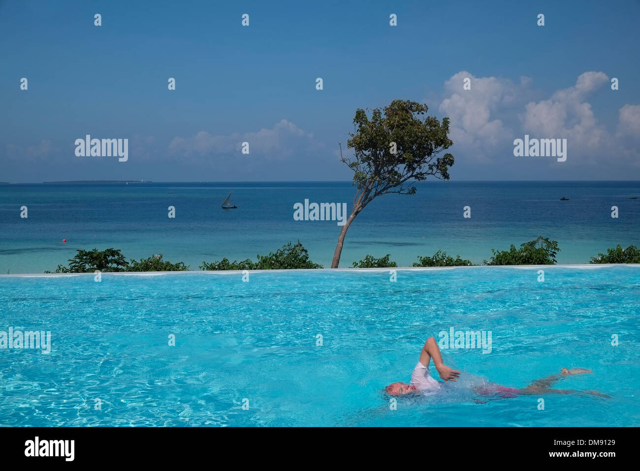A tourist swimming in the pool of Hideaway of Nungwi Resort on the ...