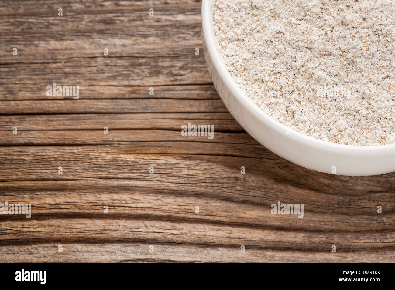 gluten free whole grain rice flour - a ceramic bowl on grained wood ...