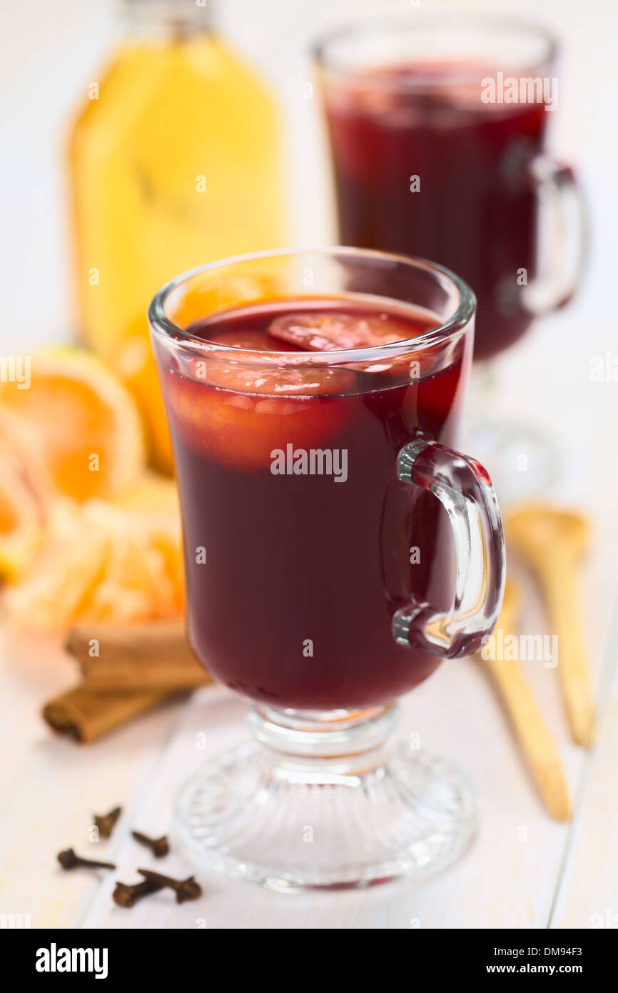 Hot spiced mulled red wine with mandarin on top, with cloves, cinnamon ...