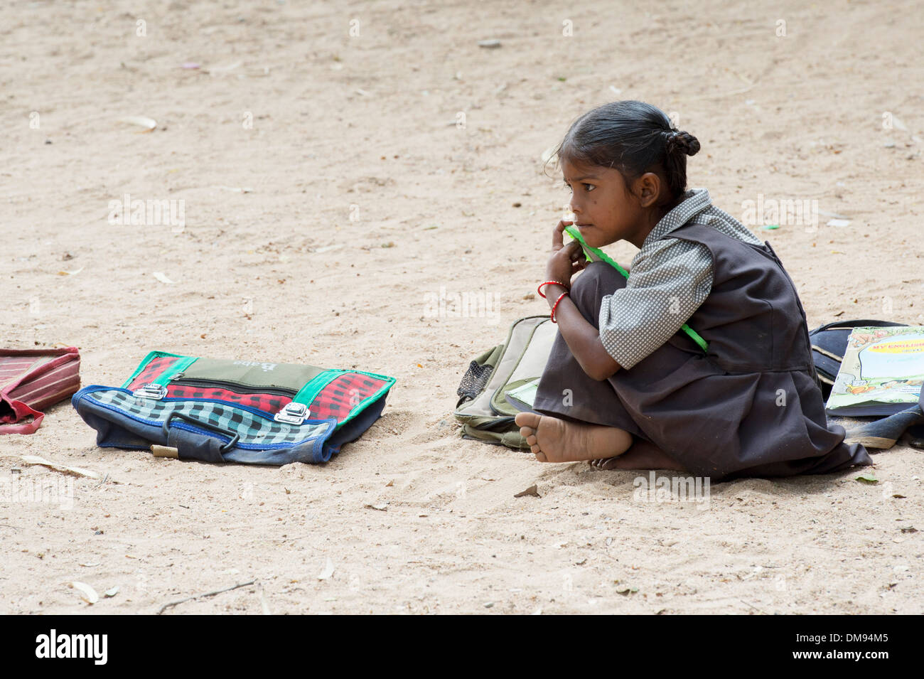 Rural Indian village school girl holding a chalk tablet in an outside ...