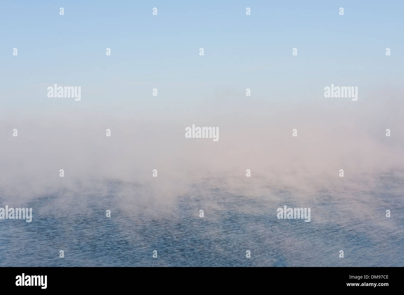 Blueish nature background of vaporing or misty sea Stock Photo - Alamy