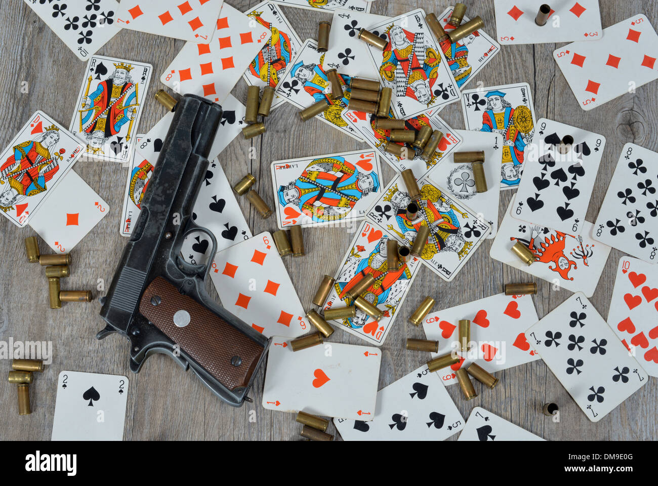 gun with somes bullets on the table with playing cards Stock Photo - Alamy