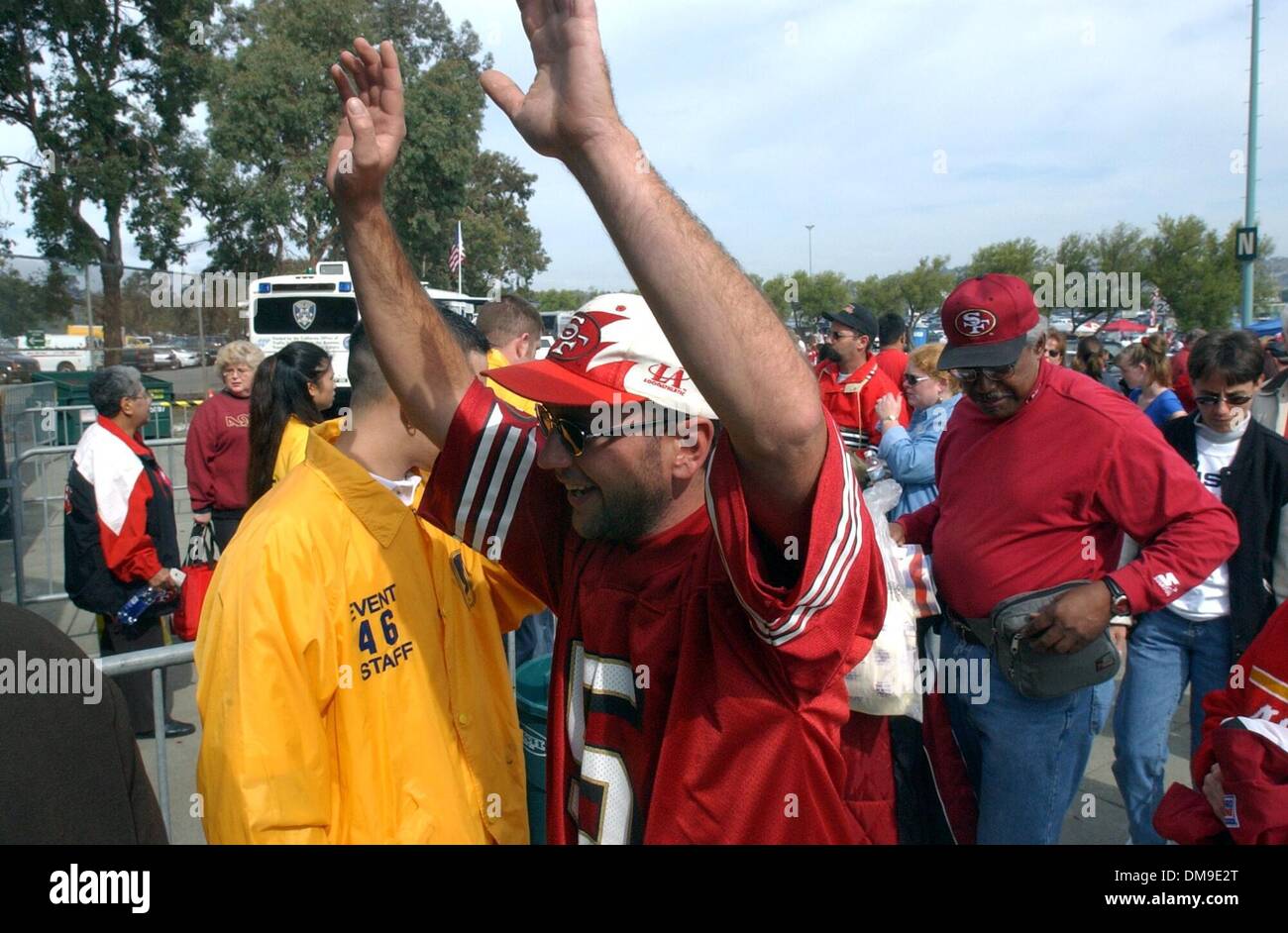A San Francisco 49ers fan puts his hands up at a entrance gate as ...