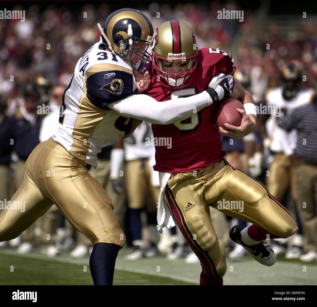 San Francisco 49ers quarterback, Jeff Garcia (5), makes a dash down ...
