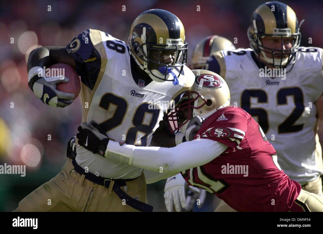 St. Louis Rams runningback Marshall Faulk (28) rushes past 49ers Zack ...