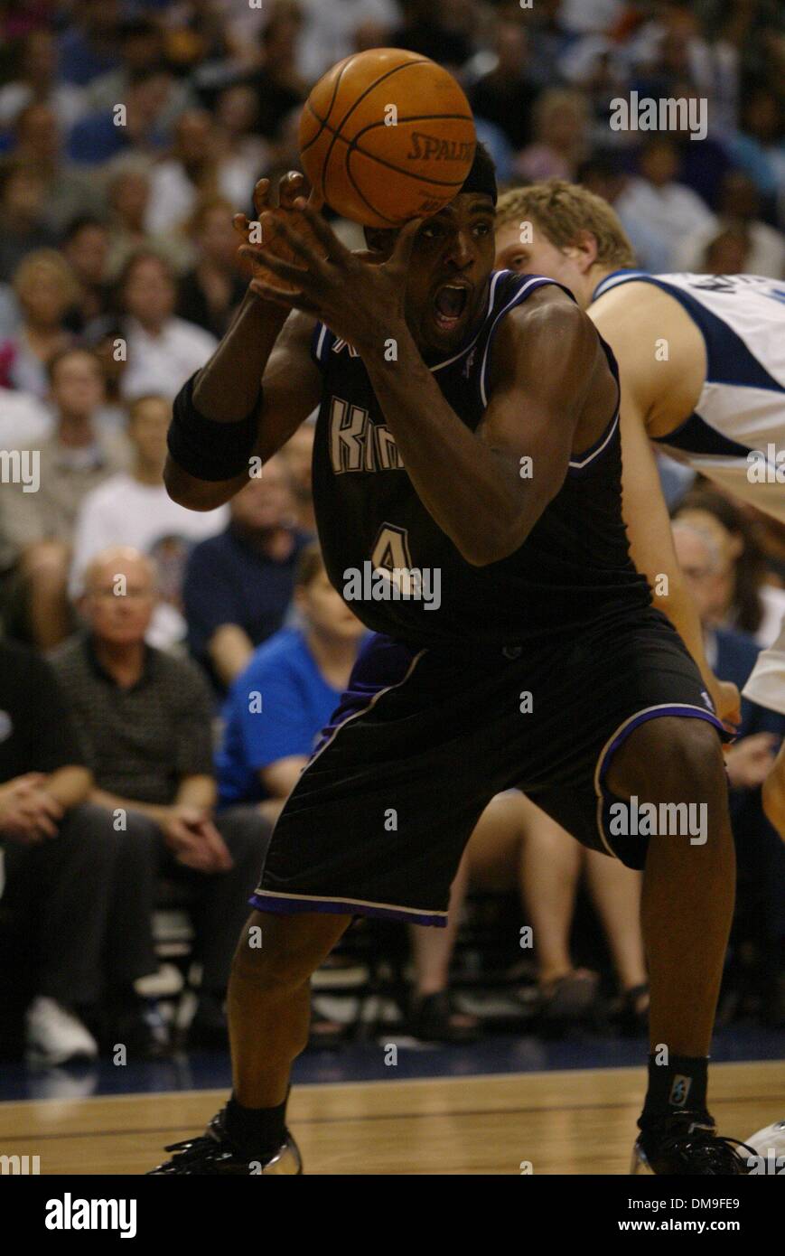 Kings forward Chris Webber spins around Mavericks forward Dirk Nowitzki ...
