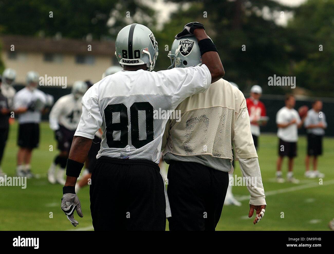 Jerry Rice (left) embraces teammate Tim Brown (right) during the ...