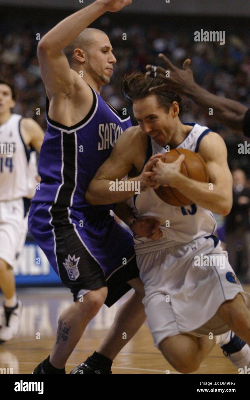 Steve Nash protects the ball while driving past Mike Bibby in the ...