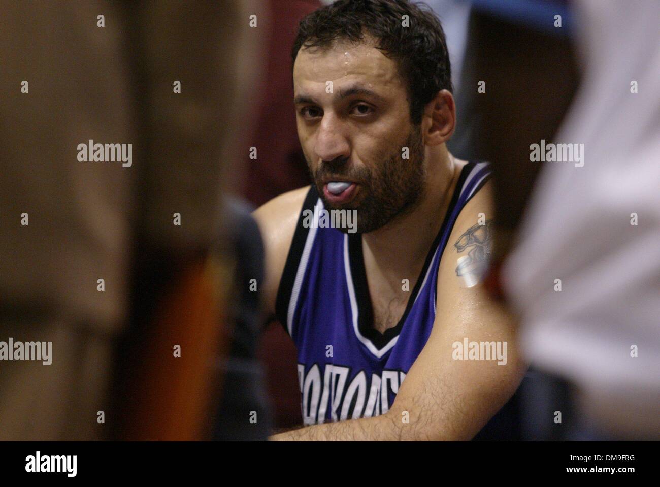 Vlade Divac sits on the bench in the second quarter and blows a bubble ...
