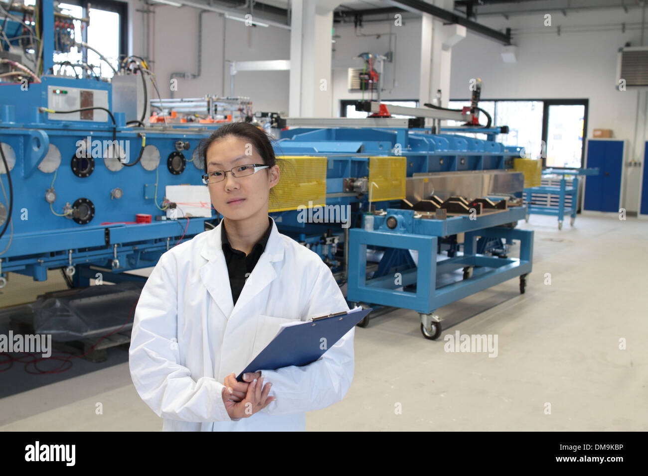 an Asia woman scientist is working in a holography lab with cleanroom ...