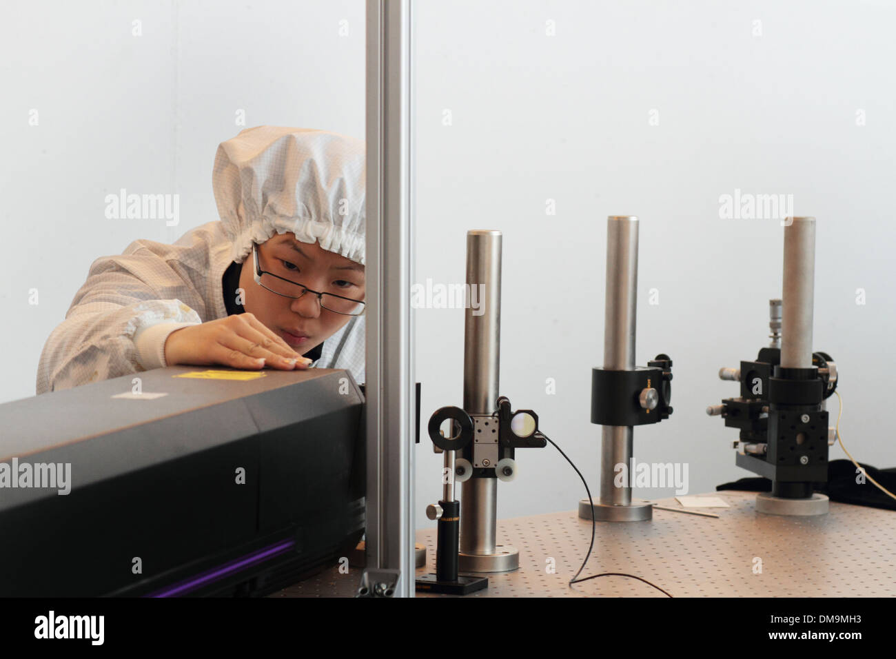 an Asia woman scientist is working in a holography lab with cleanroom ...