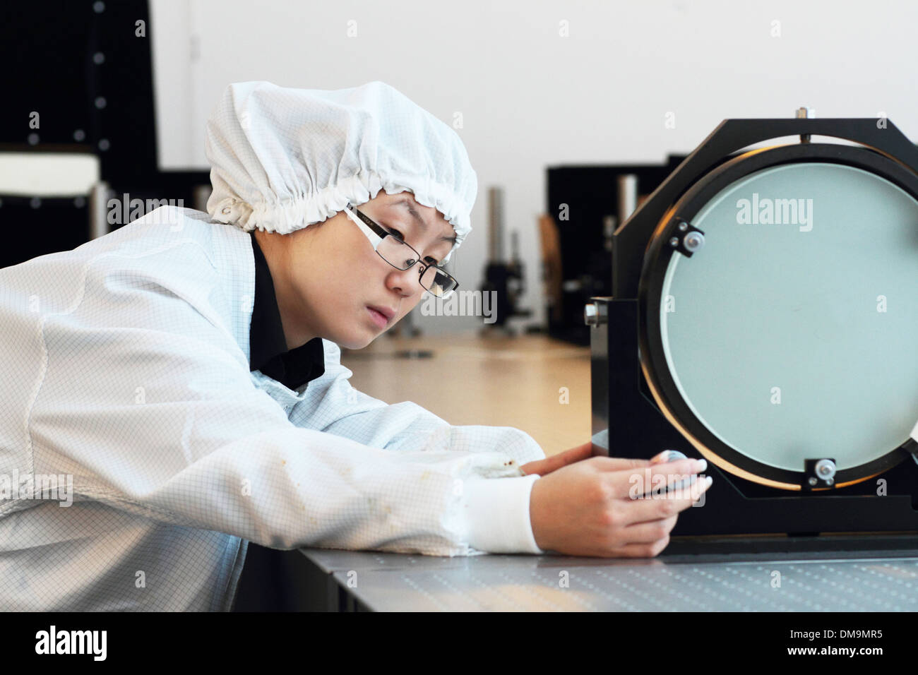 an Asia woman scientist is working in a holography lab with cleanroom ...