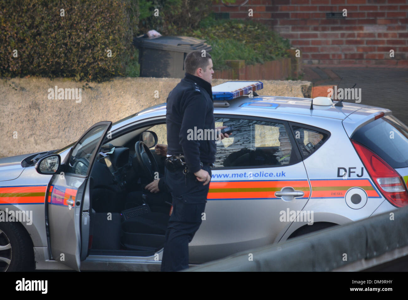 British police officer questioning suspect in vehicle and checking ...