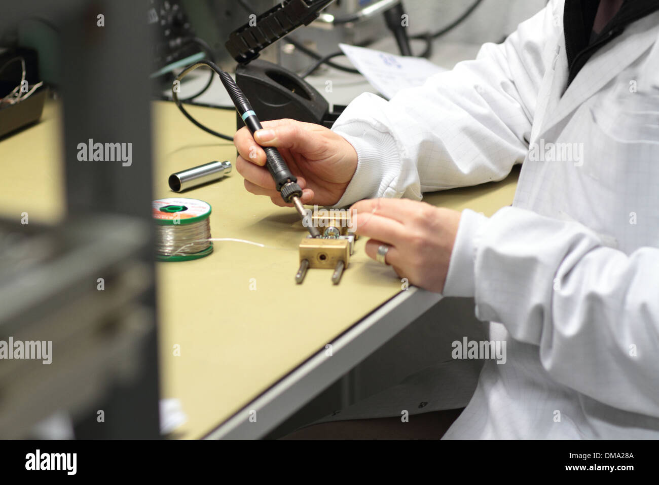 a woman in a cleanroom is building a microelectronic device Stock Photo ...
