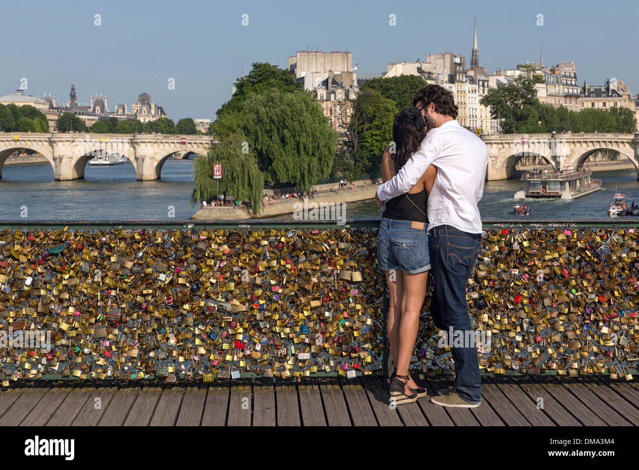 ROMANTIC COUPLE ON THE PONT DES ARTS BRIDGE COVERED IN LOVE PADLOCKS ...