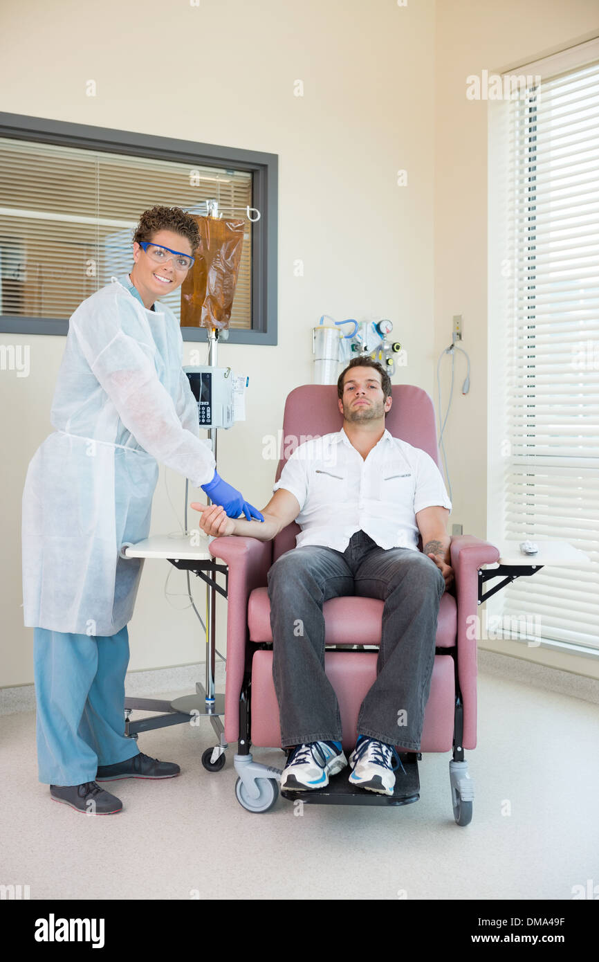Nurse Examining Patient Receiving Intravenous Treatment In Chemo Stock ...