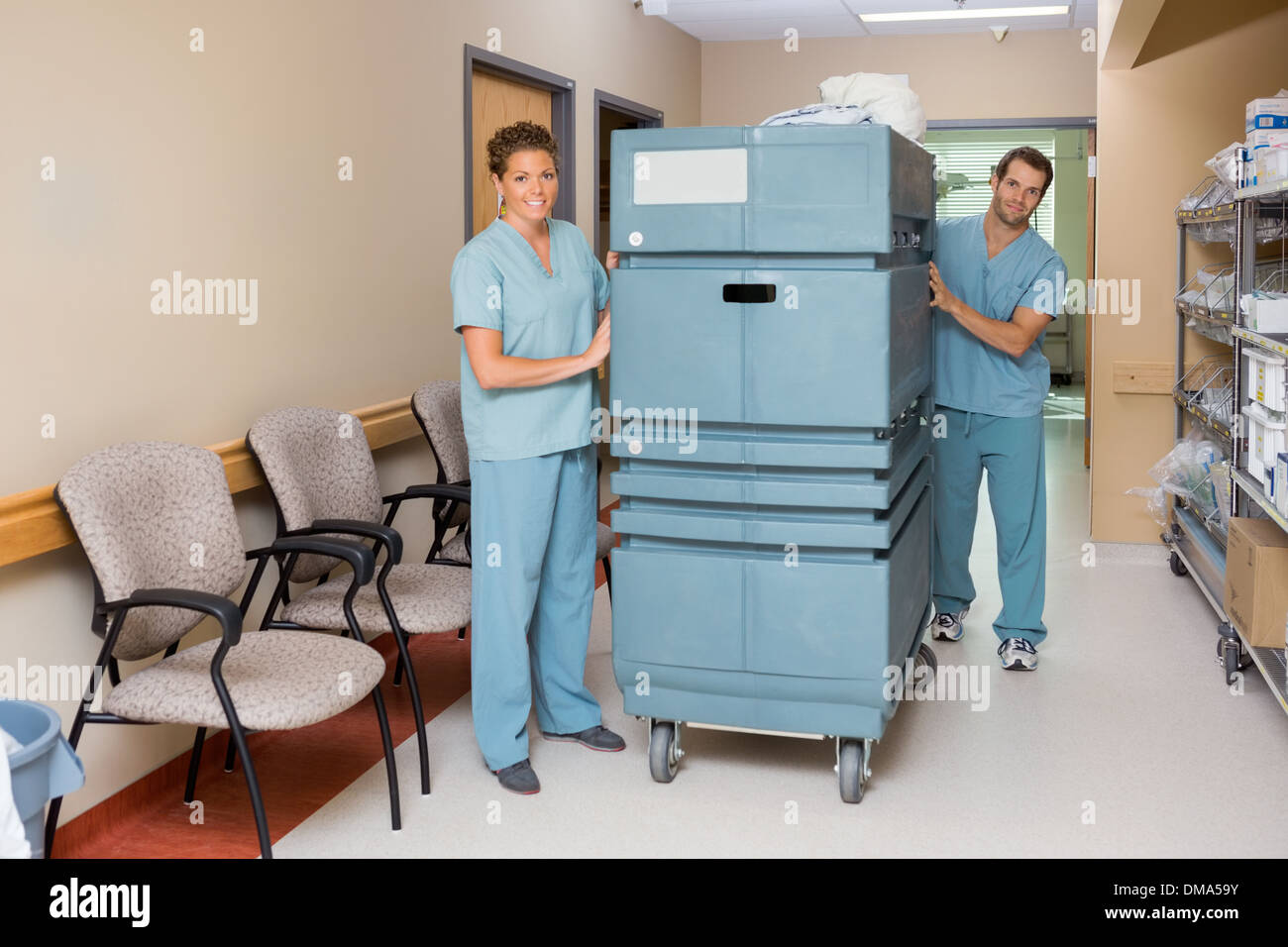 Nurses Pushing Trolley In Hospital Hallway Stock Photo - Alamy