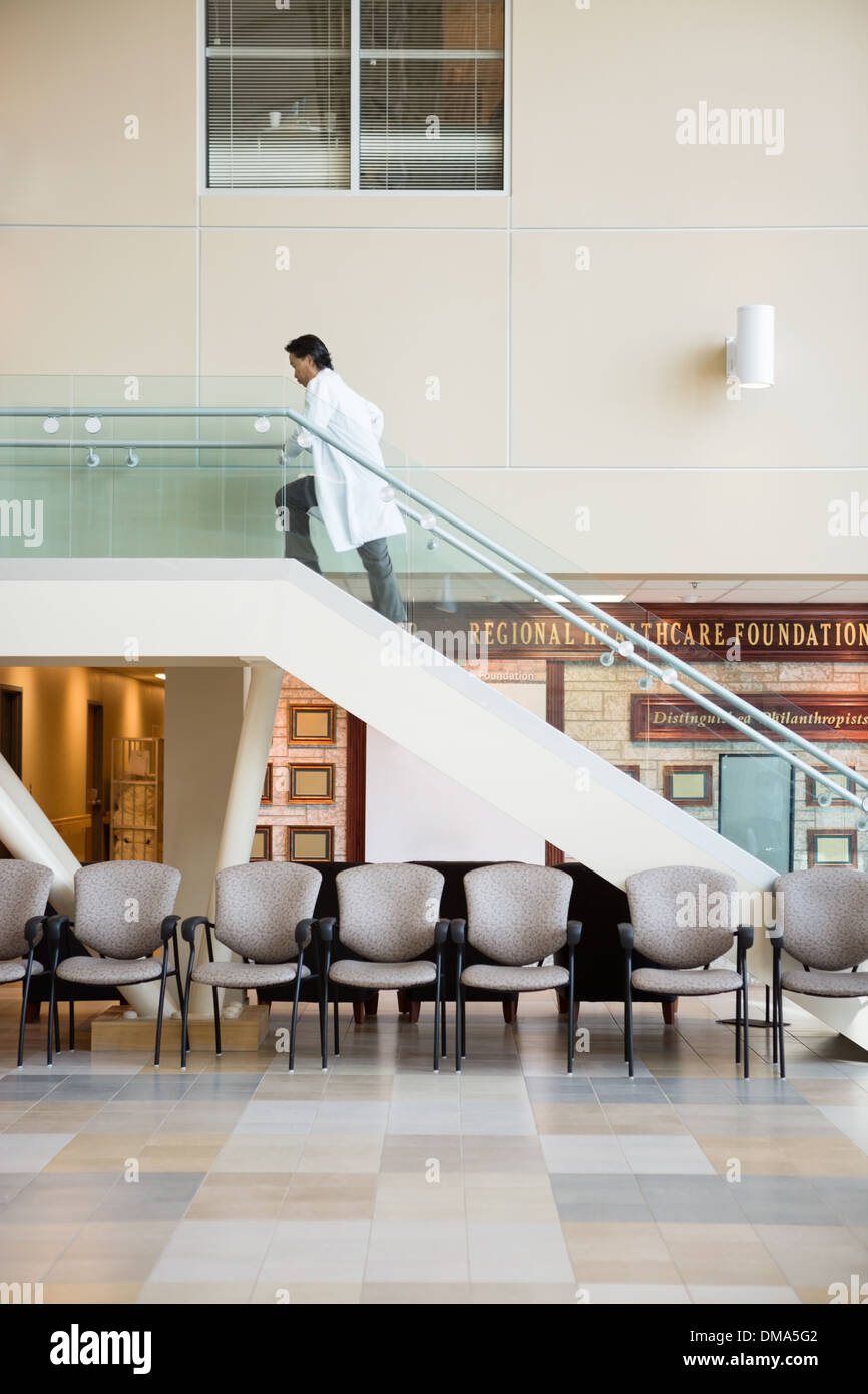 Doctor Climbing Up Stairs In Hospital Stock Photo - Alamy