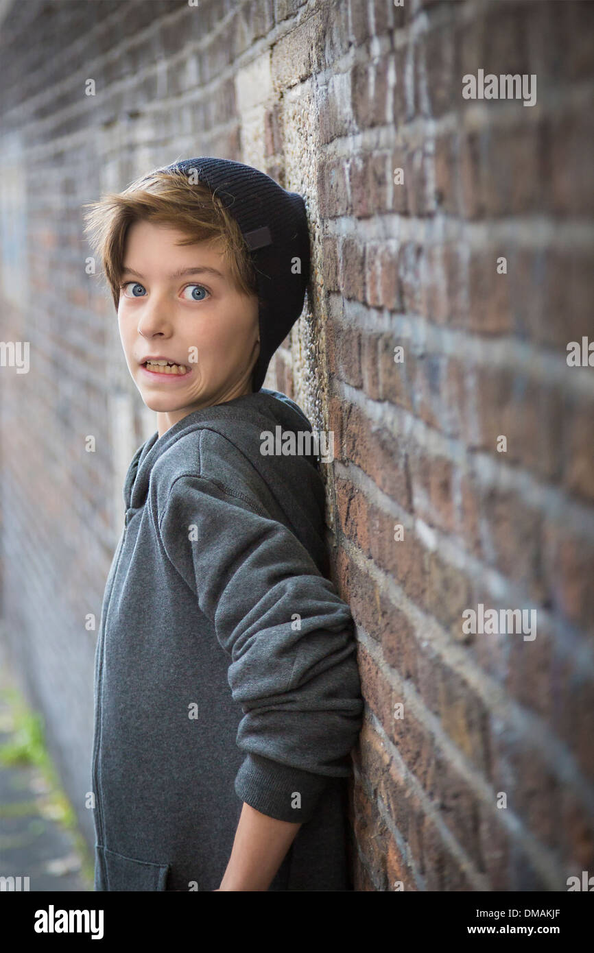terrified teenager boy leaning on a wall Stock Photo - Alamy