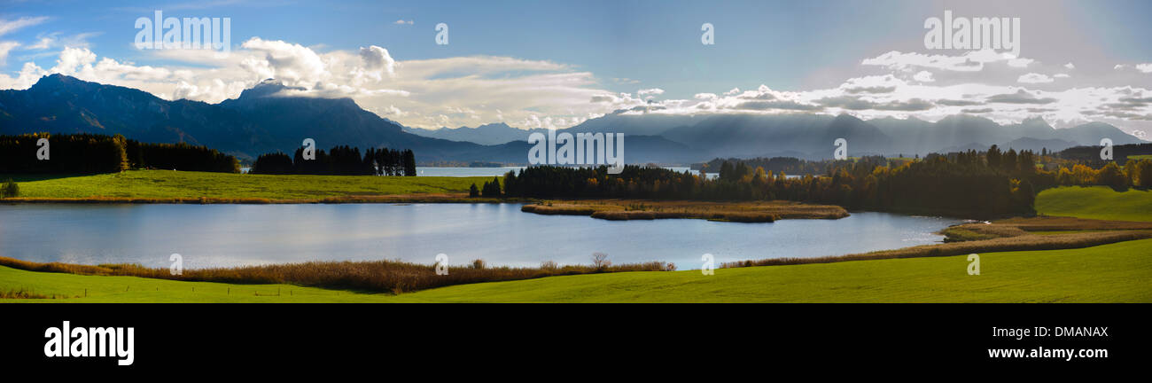 rural panorama landscape with lake Forggensee and alps mountains in ...