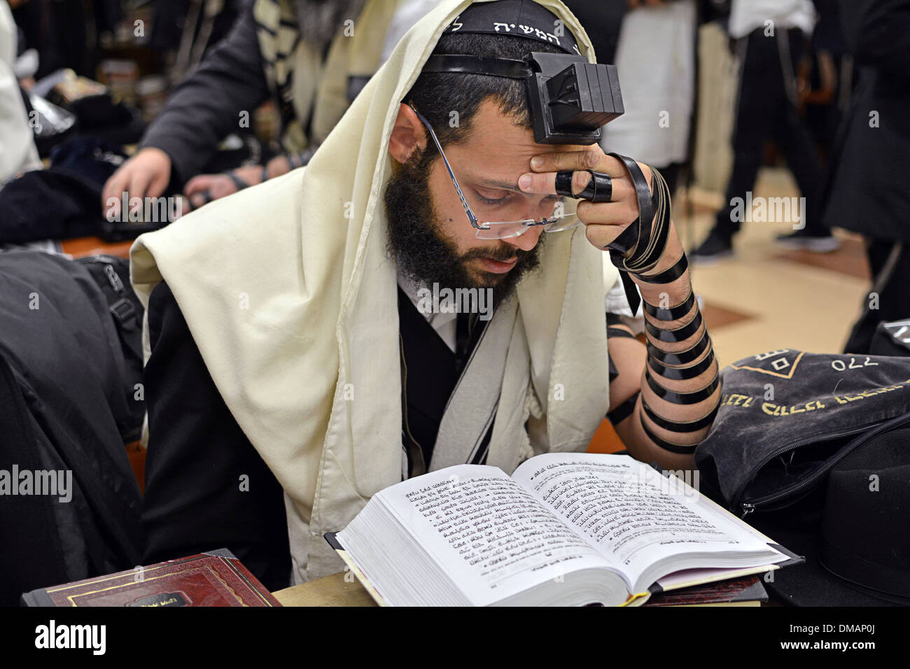 A religious young Jewish man with a beard at morning prayers at the ...