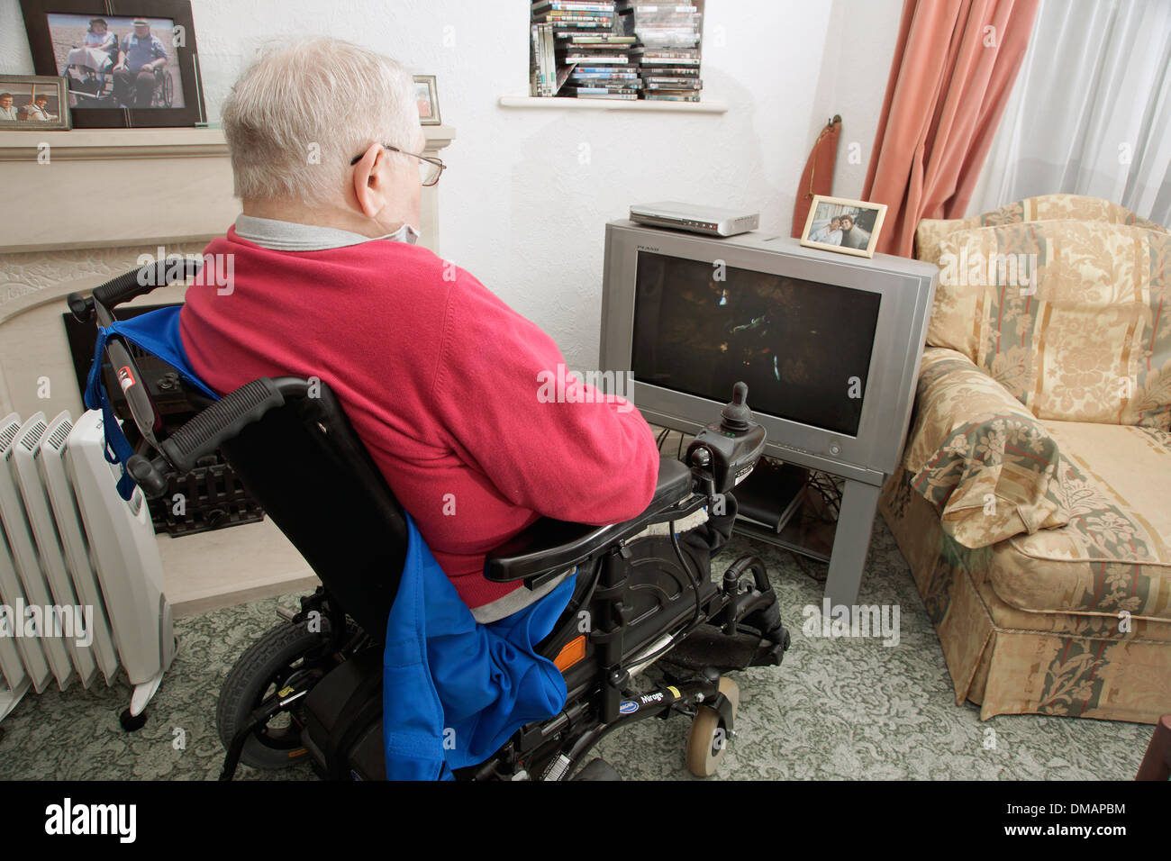 Disabled elderly man in a wheelchair watching the television Stock ...