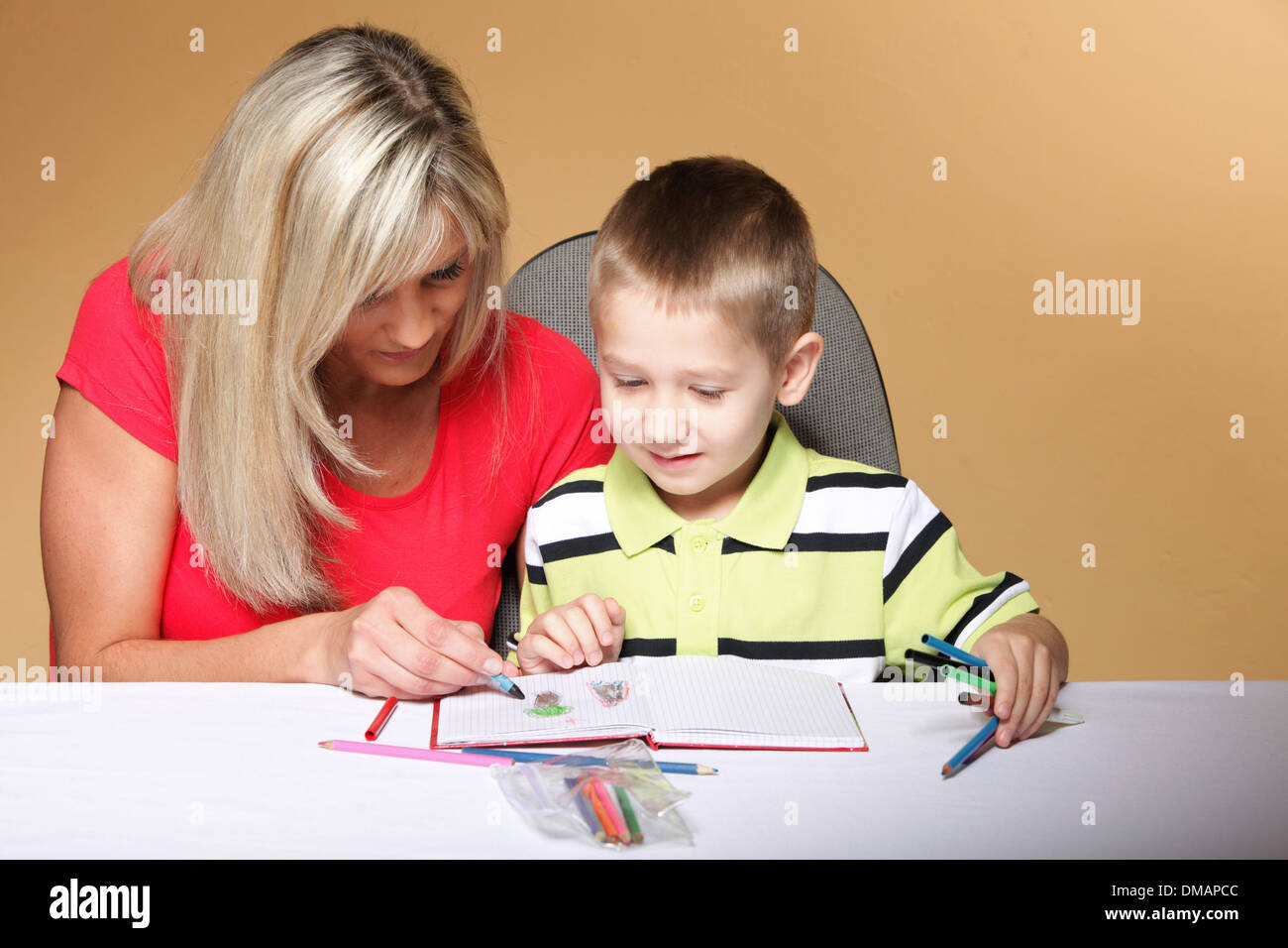mother and son drawing together, mom helping with homework daycare ...