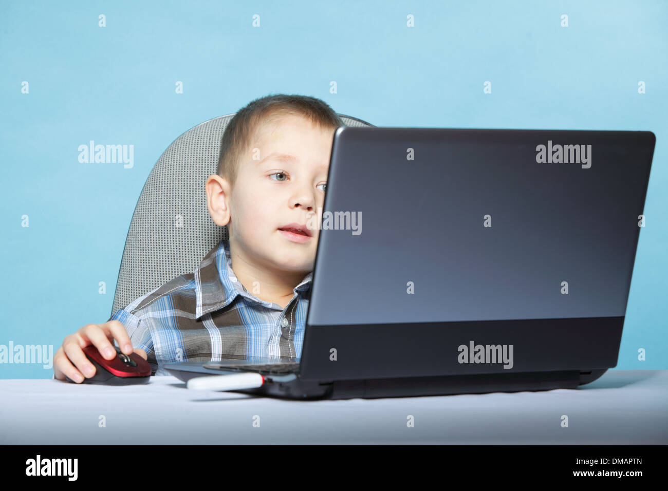 Computer addiction child boy with laptop notebook blue background Stock ...