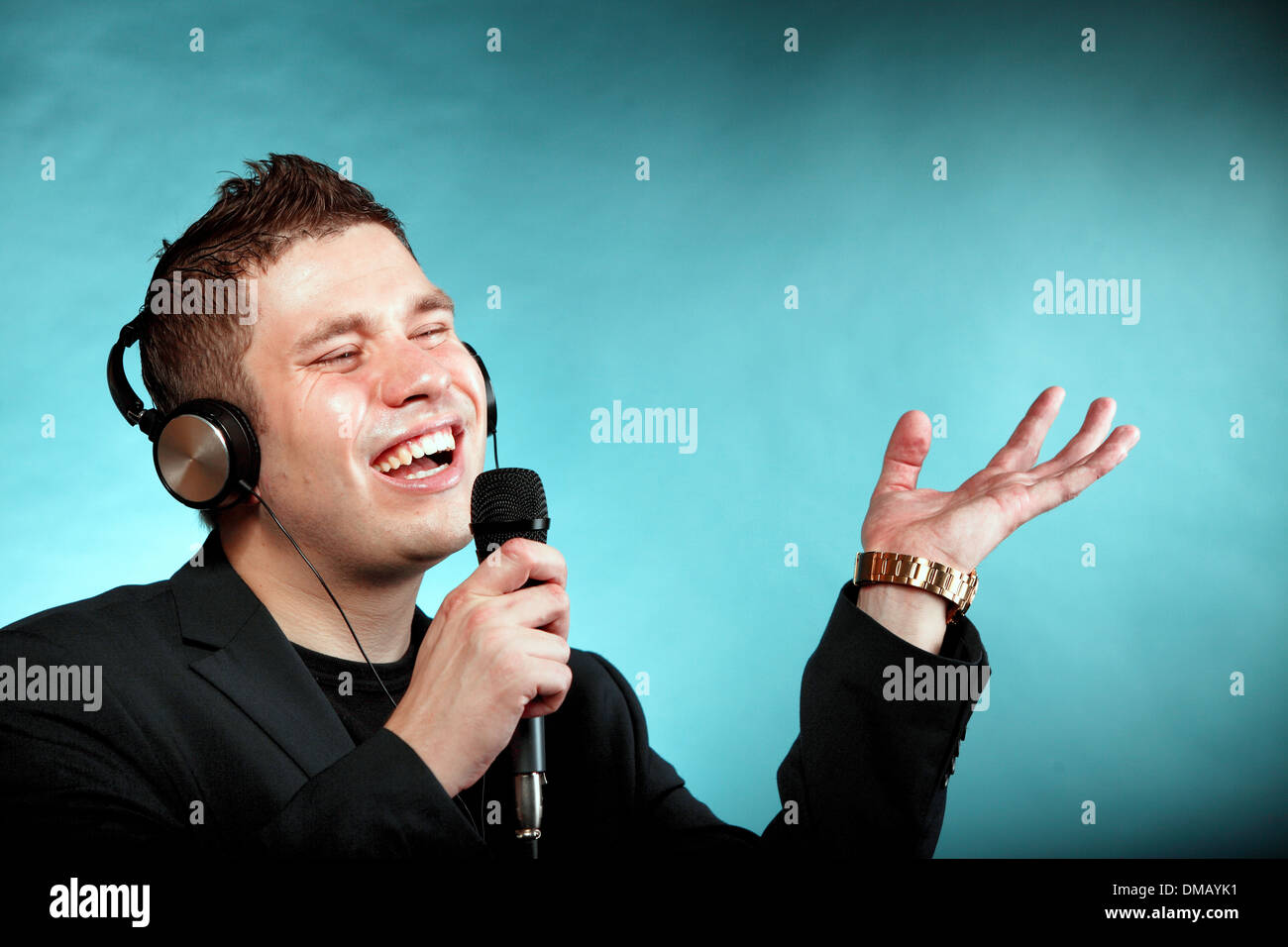 Man singing into microphone happy karaoke signer Stock Photo - Alamy