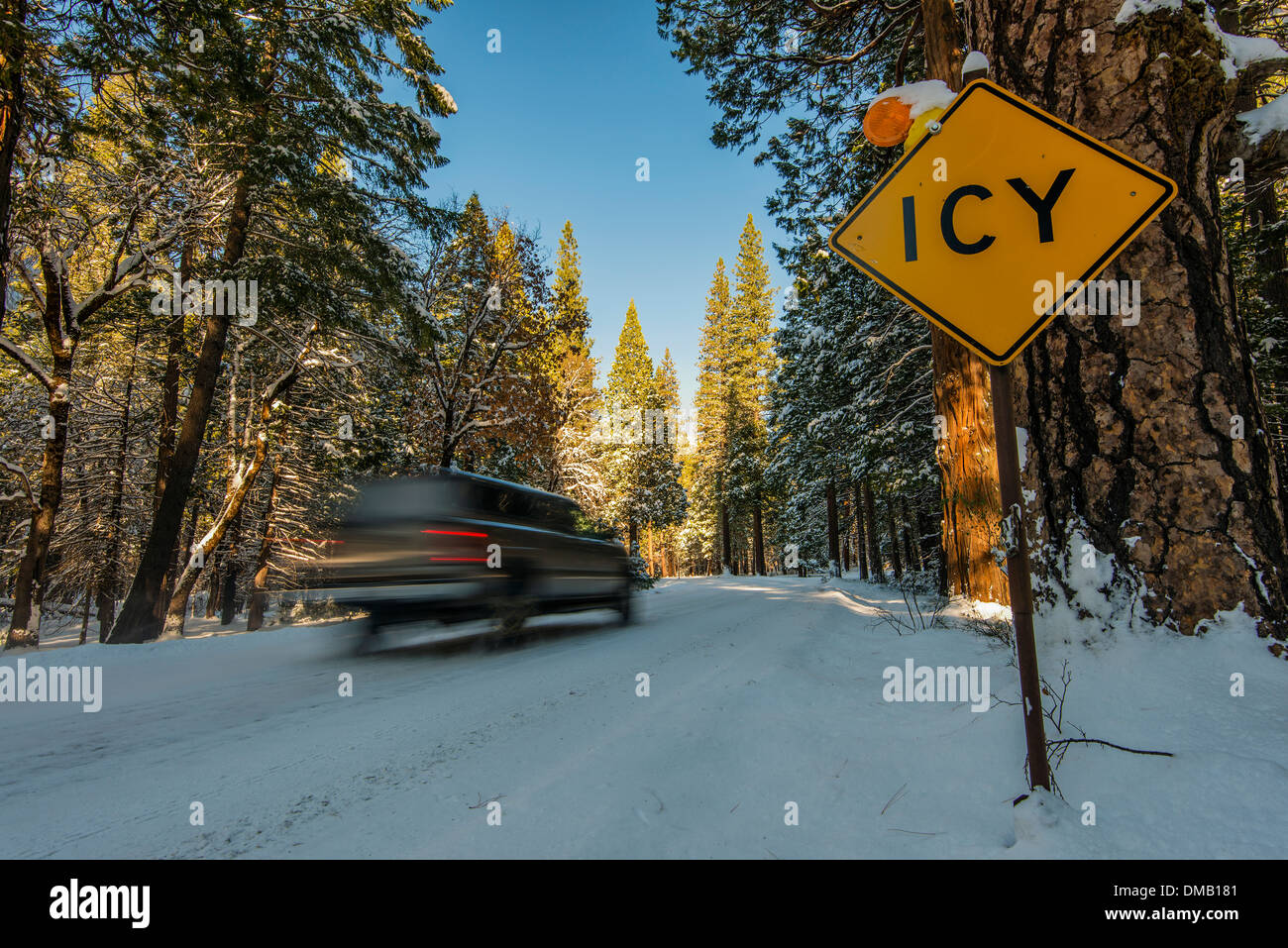 Road icing warning yellow sign on a snowy road, Yosemite National Park ...