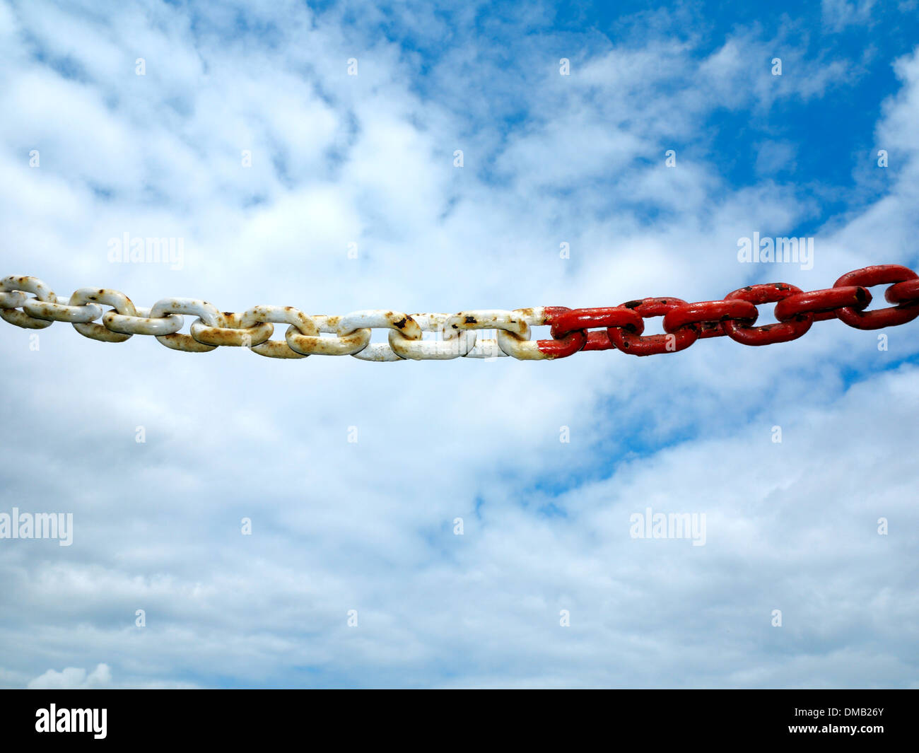 Old rusty metal steel red white chain links segment. Sky cloudy ...