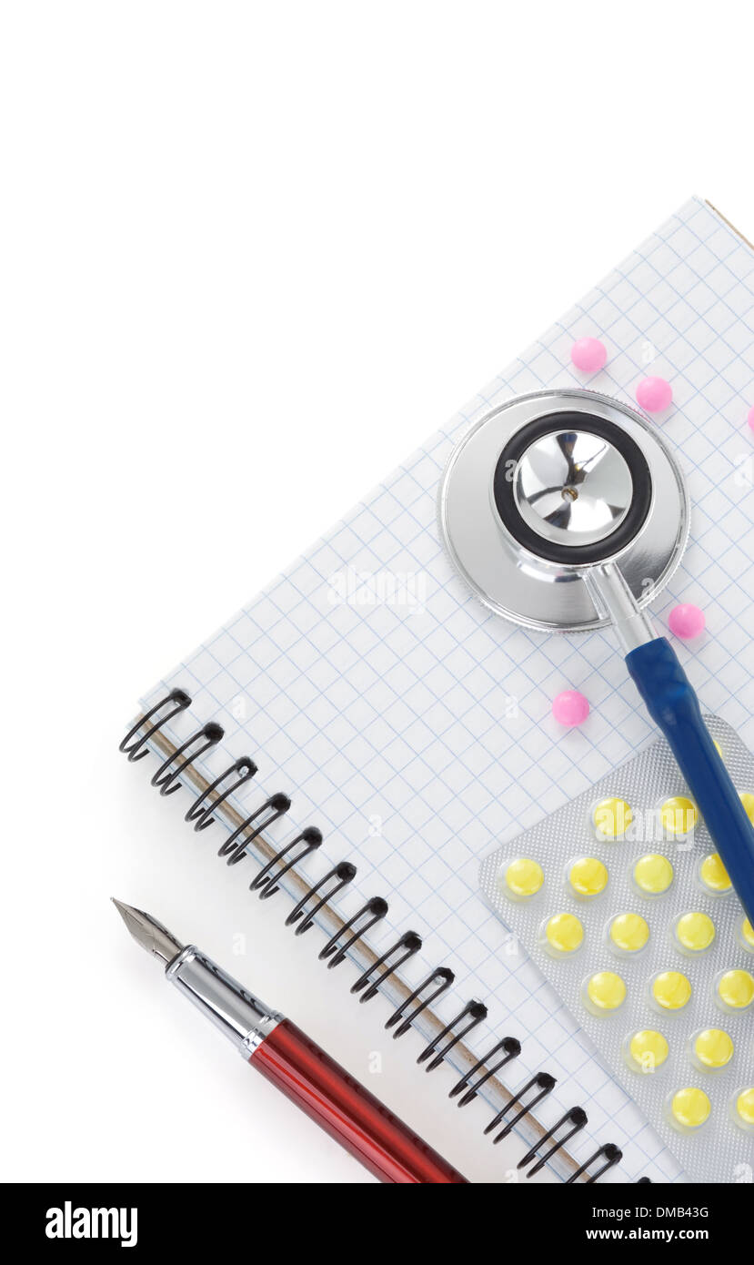 medical stethoscope with pills and notebook isolated on white ...