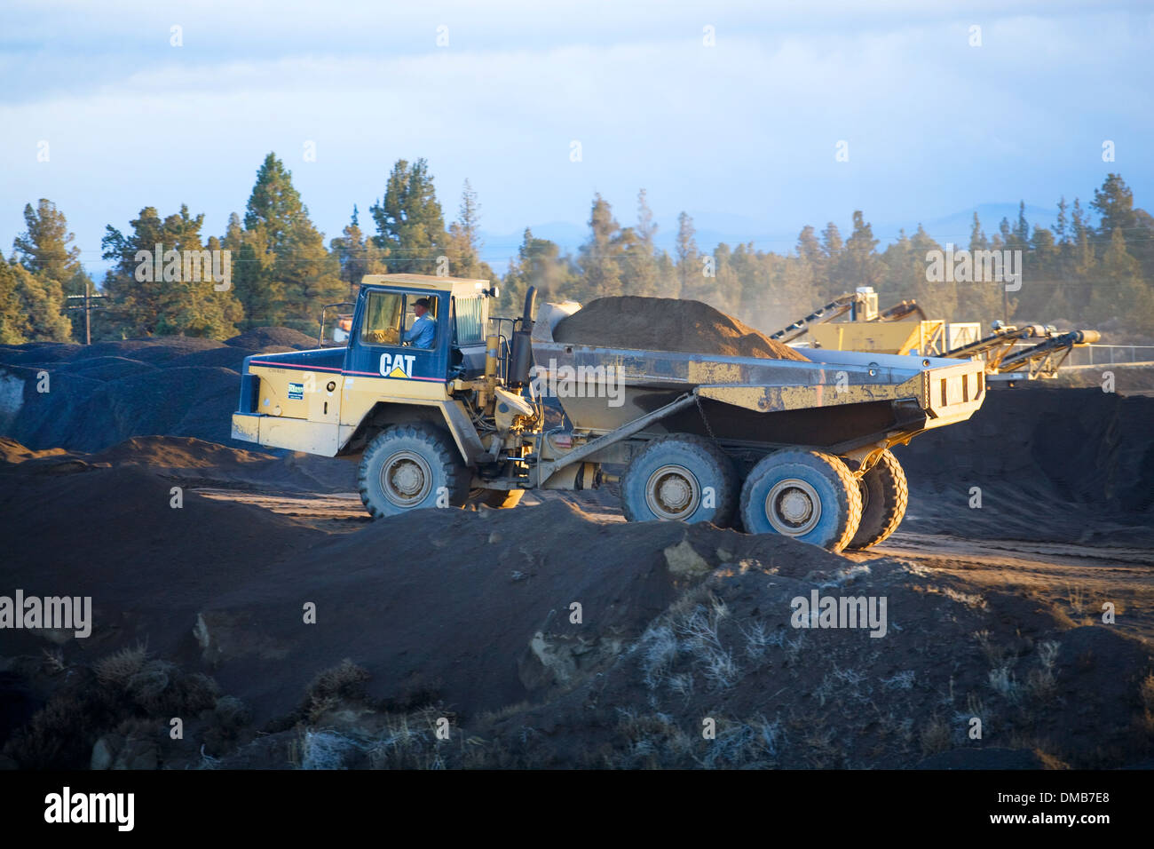 A giant Caterpillar dump truck moving earth Stock Photo - Alamy