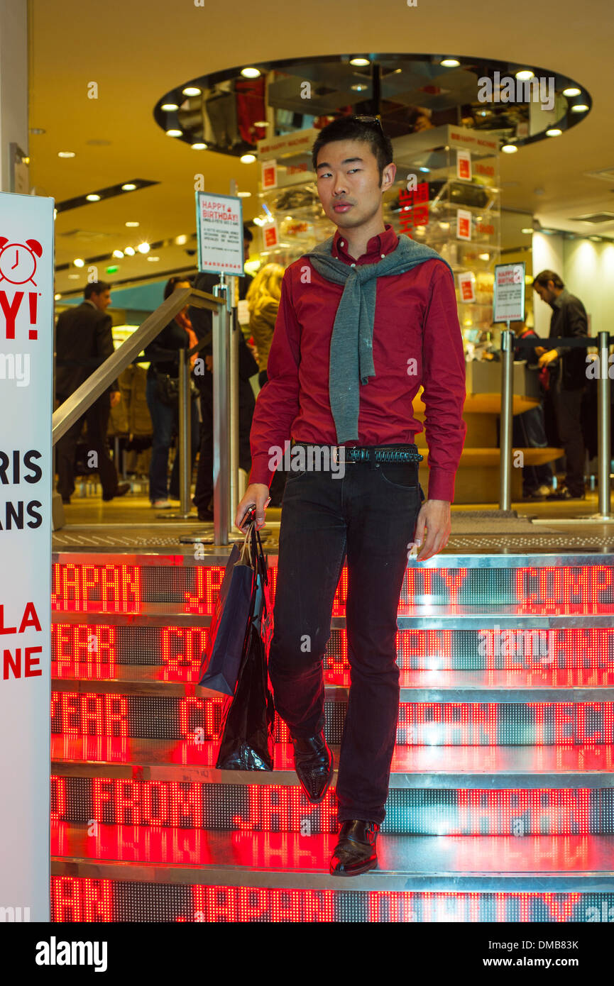 Paris, France, Young Chinese Man with Shopping Bags inside Uniglo ...