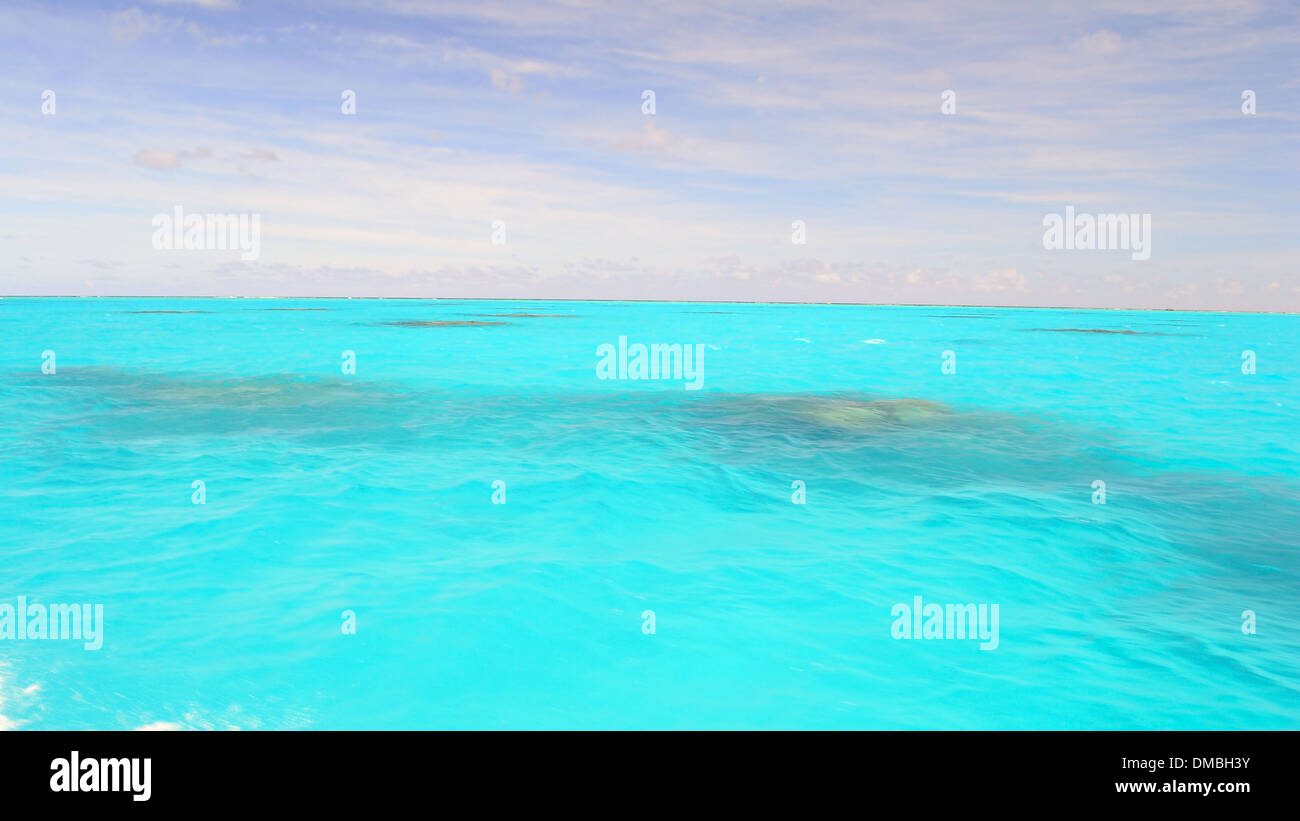 The colorful Aitutaki lagoon spotted by coral reef, in the middle of ...
