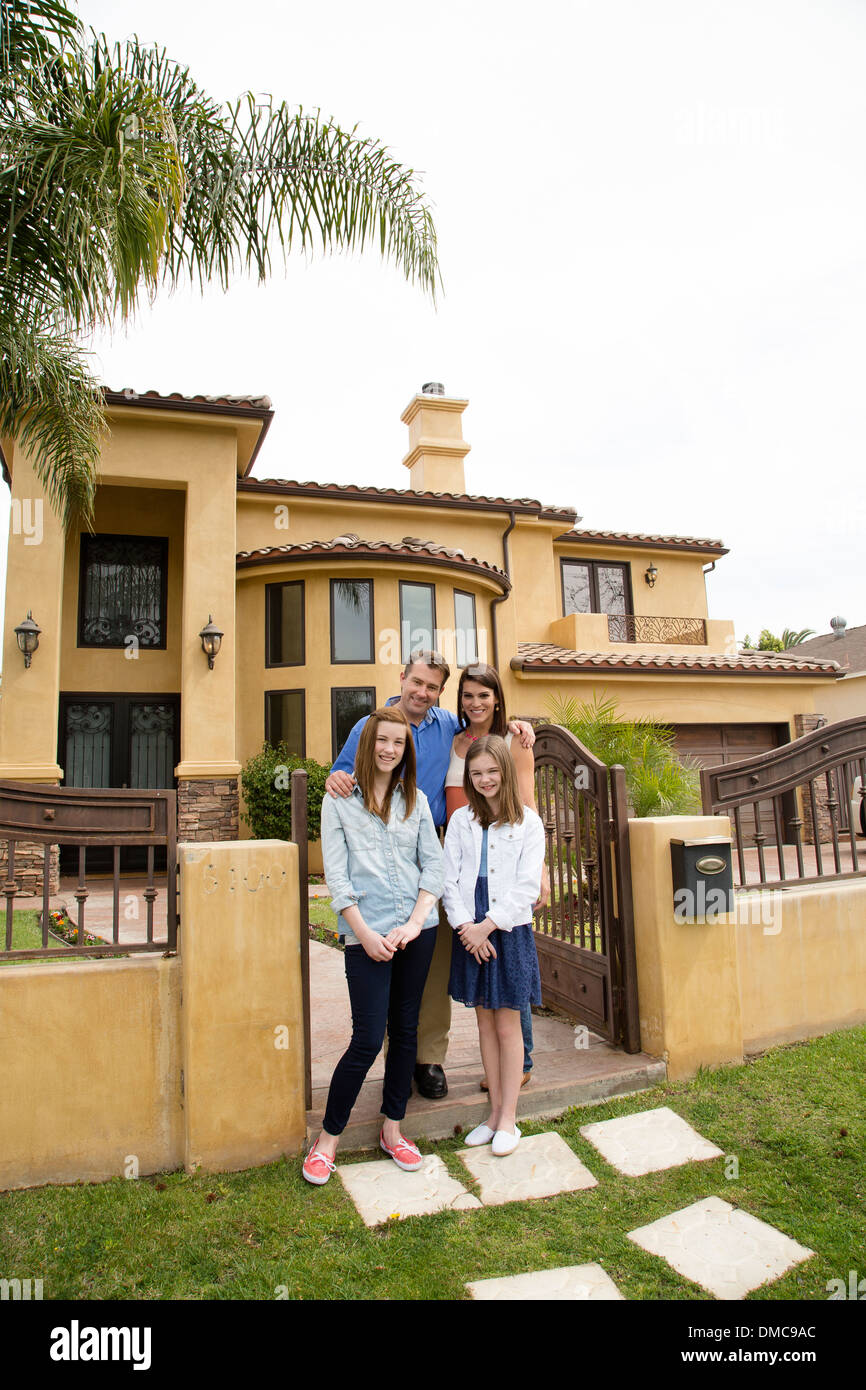 Family portrait in front of home Stock Photo - Alamy