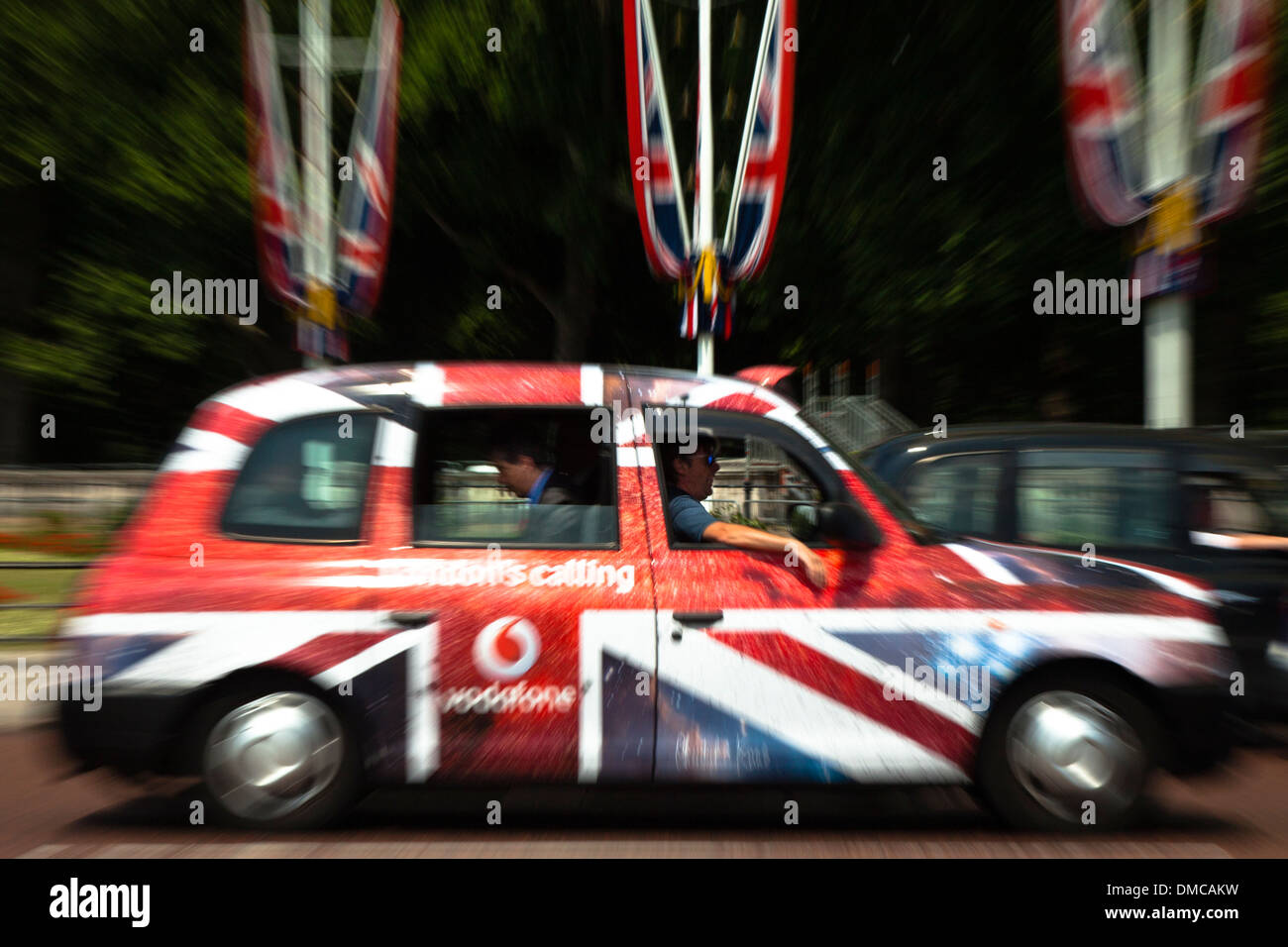 London taxi with Union Jack flags Stock Photo - Alamy