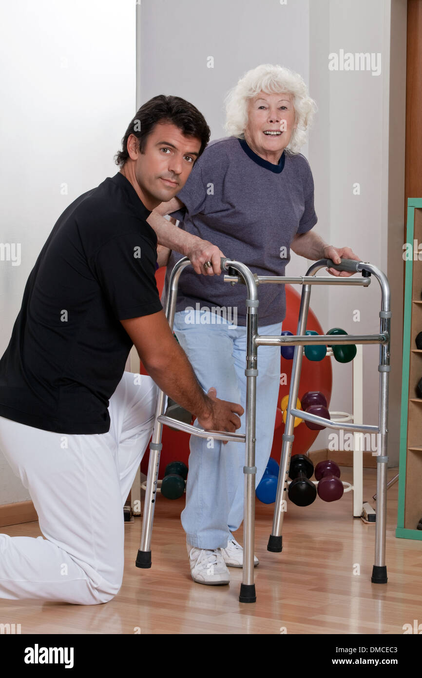 Therapist helping Patient use Walker Stock Photo - Alamy