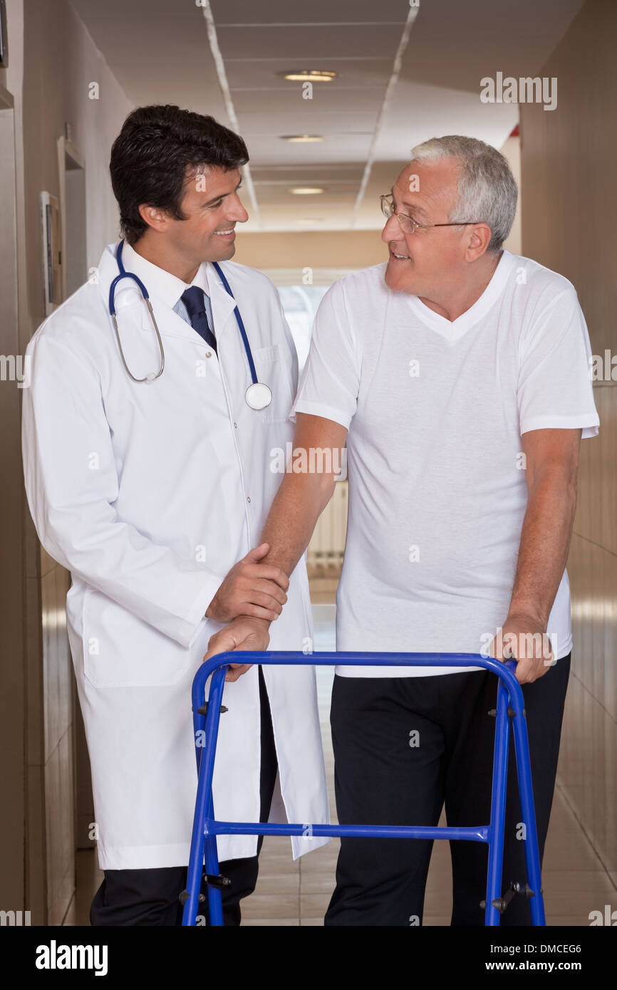 Doctor helping Patient use Walker Stock Photo - Alamy