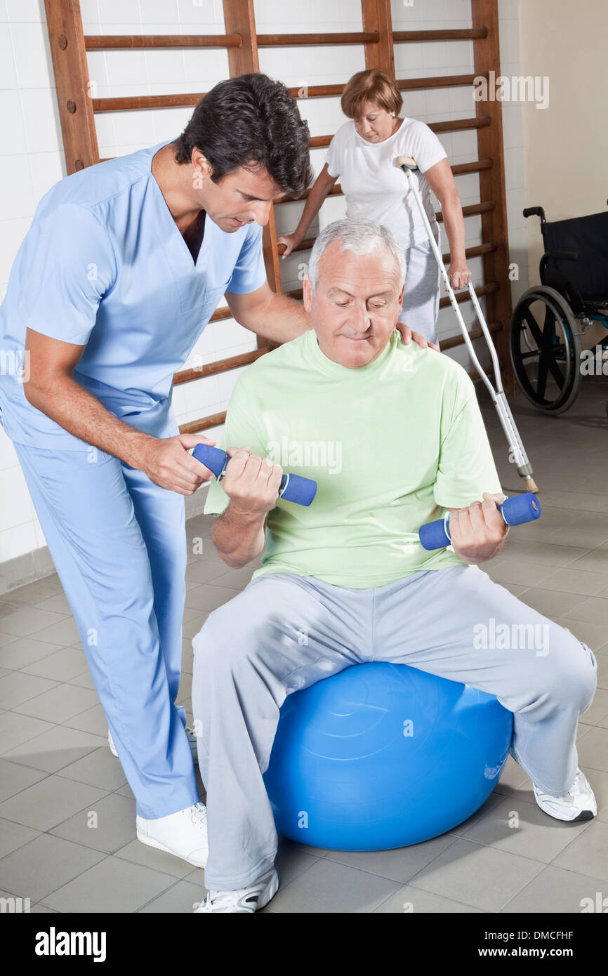 Physical Therapist helping a Patient Stock Photo - Alamy