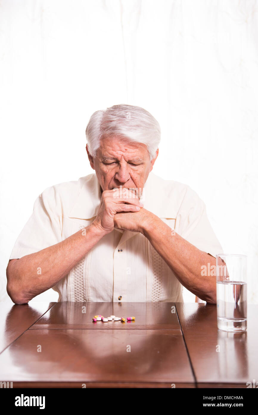 Ederly man preparing to take his medication Stock Photo - Alamy