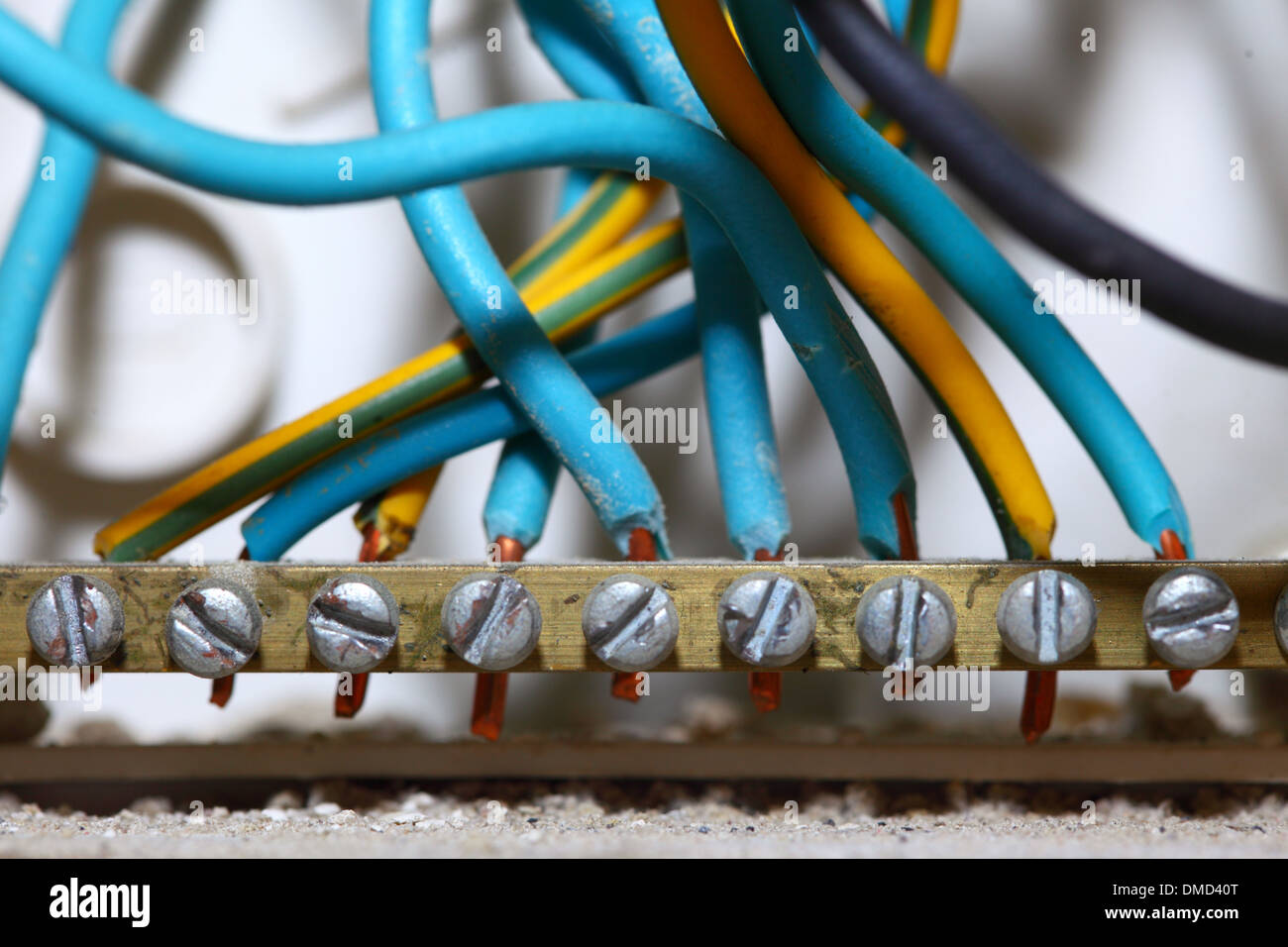 Electrical installation. Close up electric wires hanging on wall ...