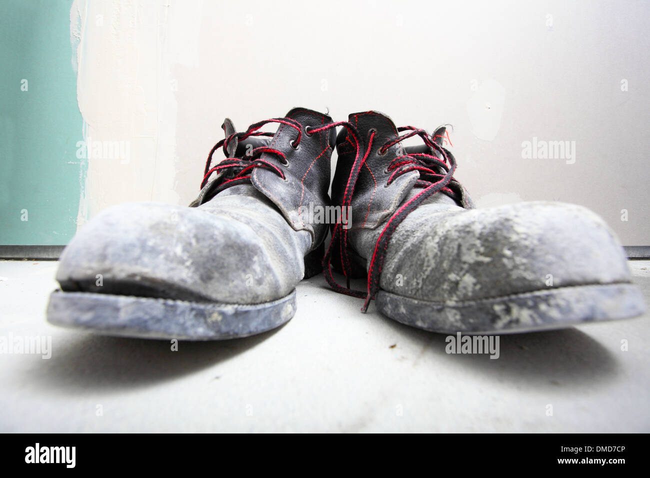 pair of old dirty work boots in construction site Stock Photo - Alamy