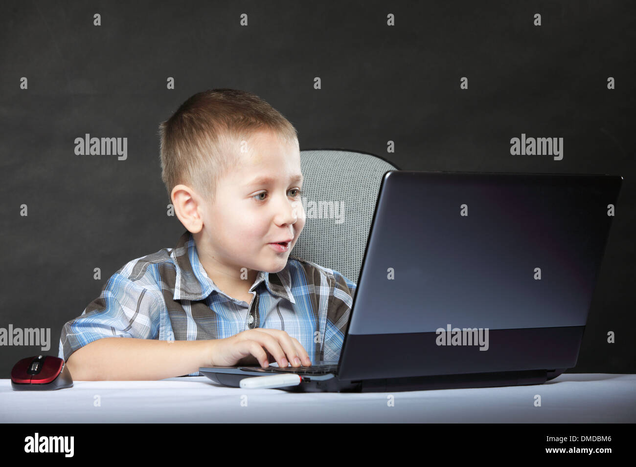 Computer addiction child boy with laptop notebook black background ...