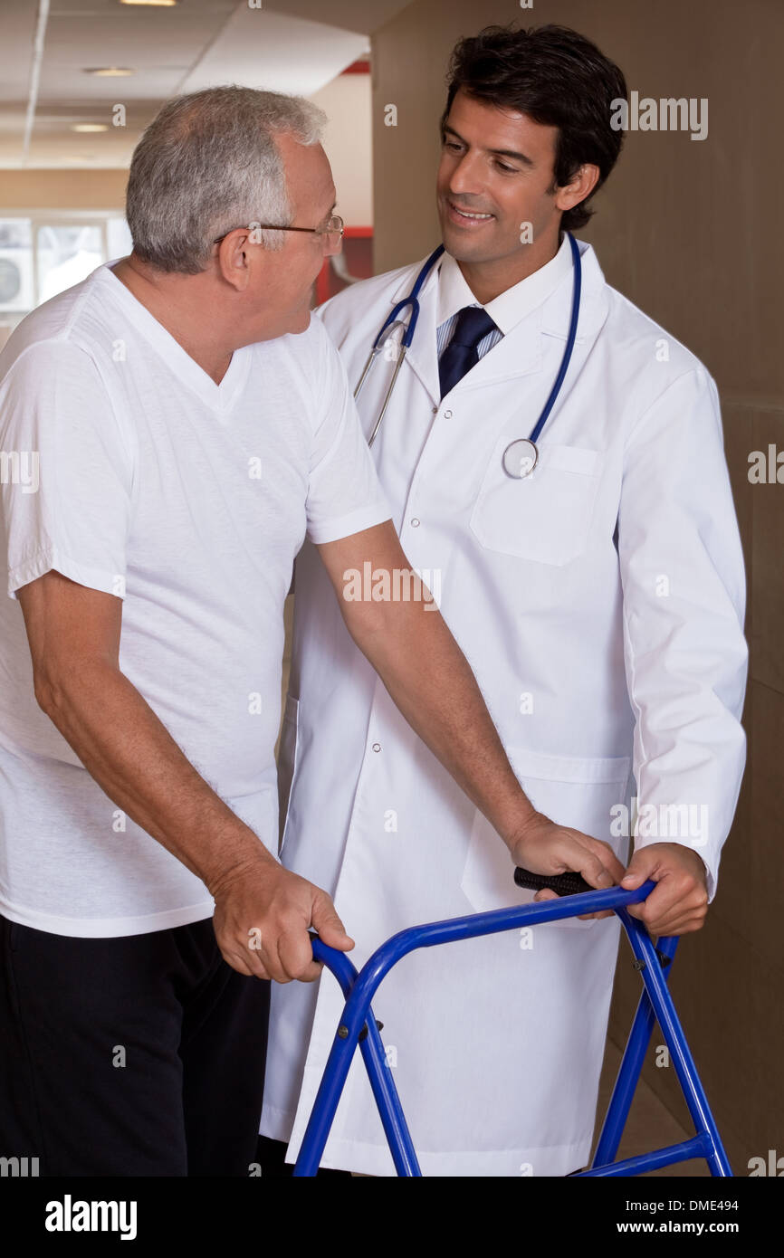 Doctor helping Patient use Walker Stock Photo - Alamy