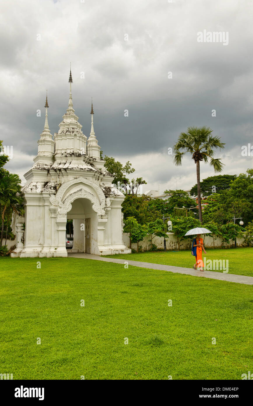 Monk walking through the entrance gate to Wat Suan Dok Temple, Chiang ...