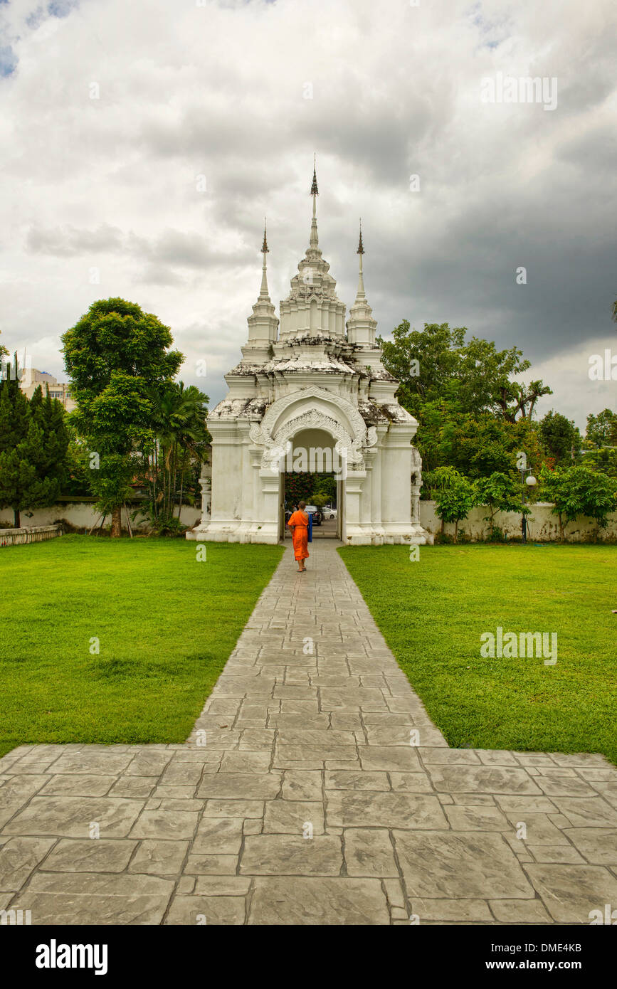 Monk walking through the entrance gate to Wat Suan Dok Temple, Chiang ...